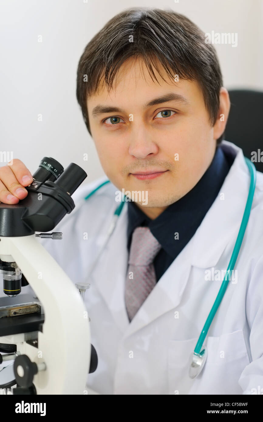 Portrait of male researcher working with microscope Stock Photo - Alamy