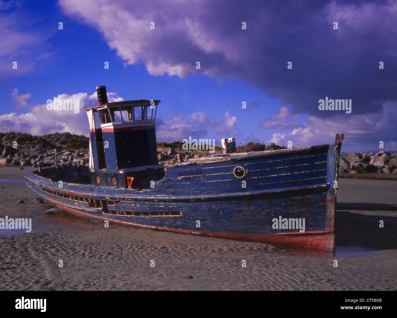 A view toward a beached fishing boat Stock Photo - Alamy