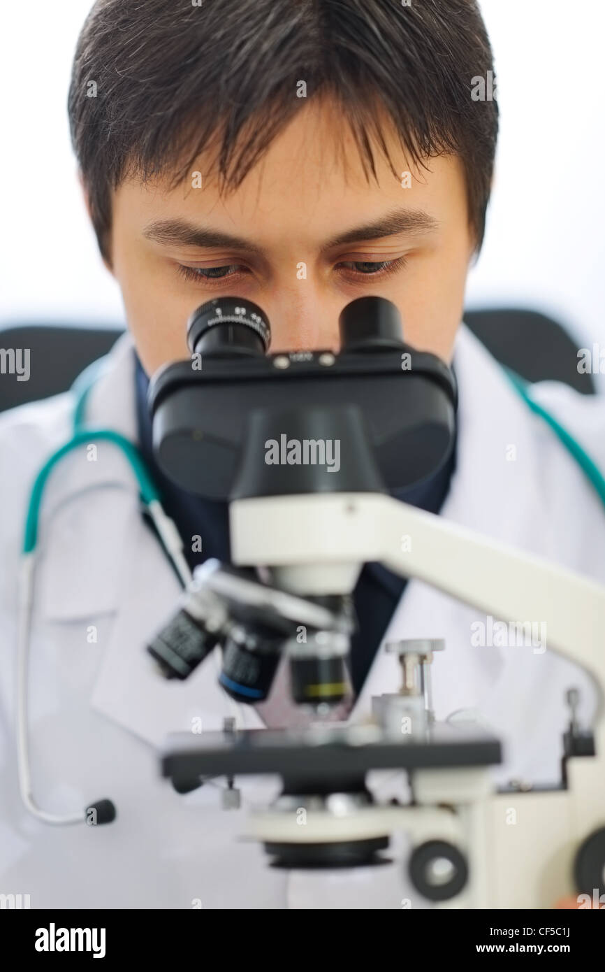Closeup on medical doctor looking in microscope Stock Photo - Alamy