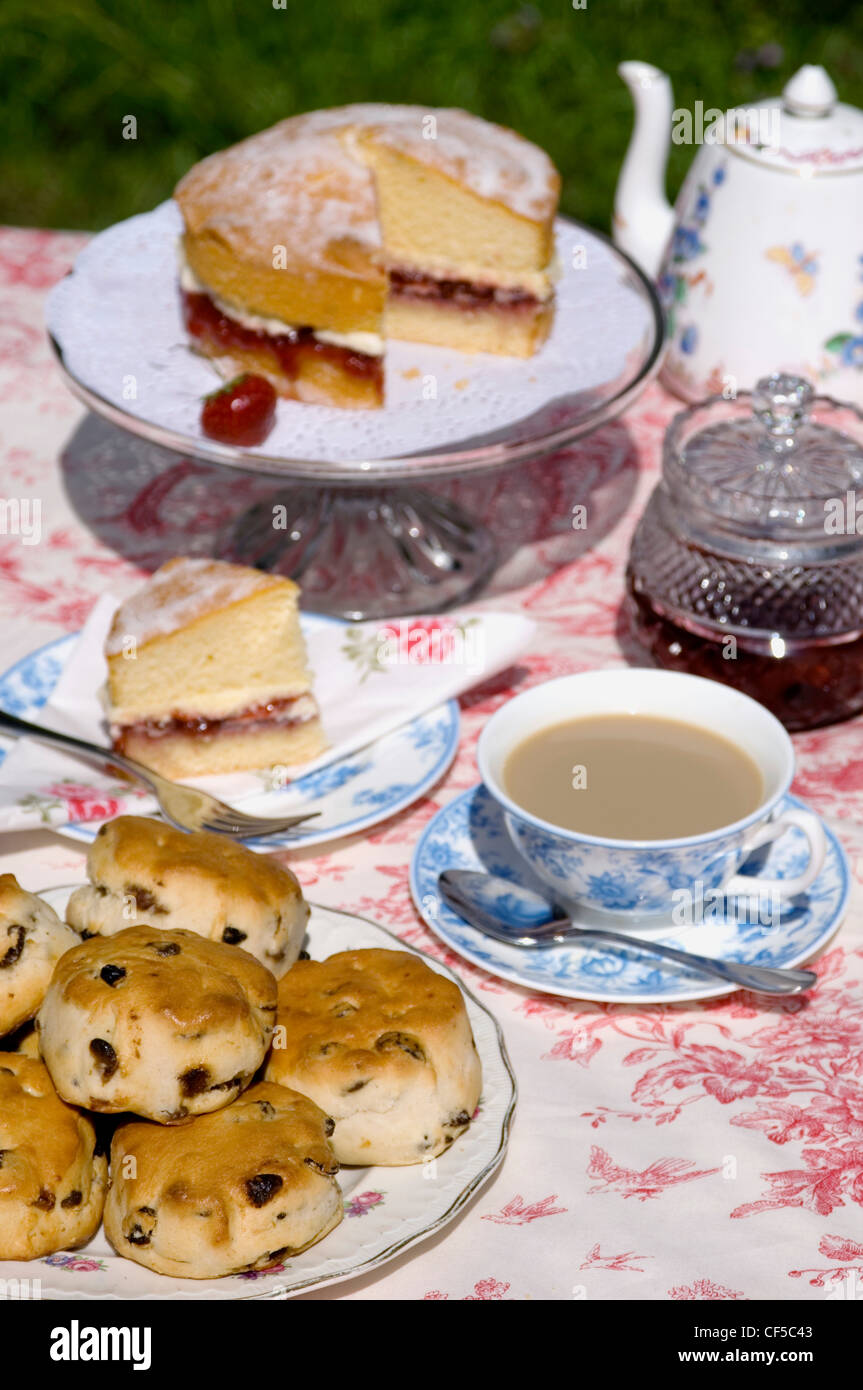 An English cream tea Plate of scones, cup of tea, victoria sponge cake ...
