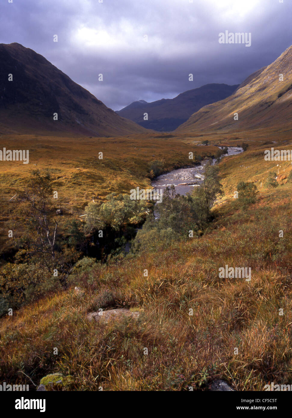 View of Glen Etive from road with sunlight breaking through storm ...