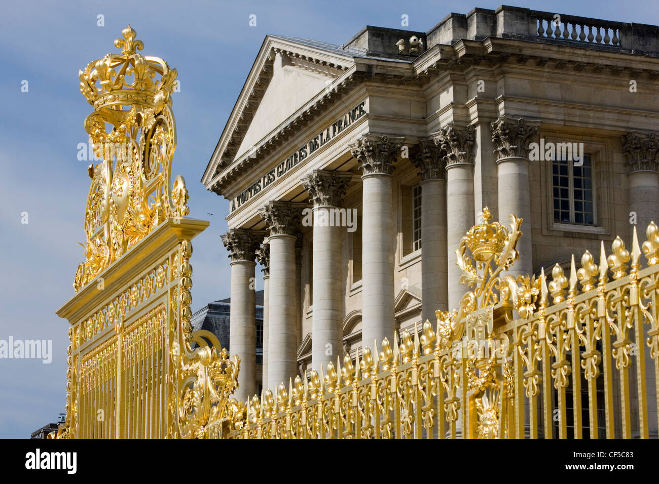 Gold gilded gates, colonnades and pediment at The Palace of Versailles ...