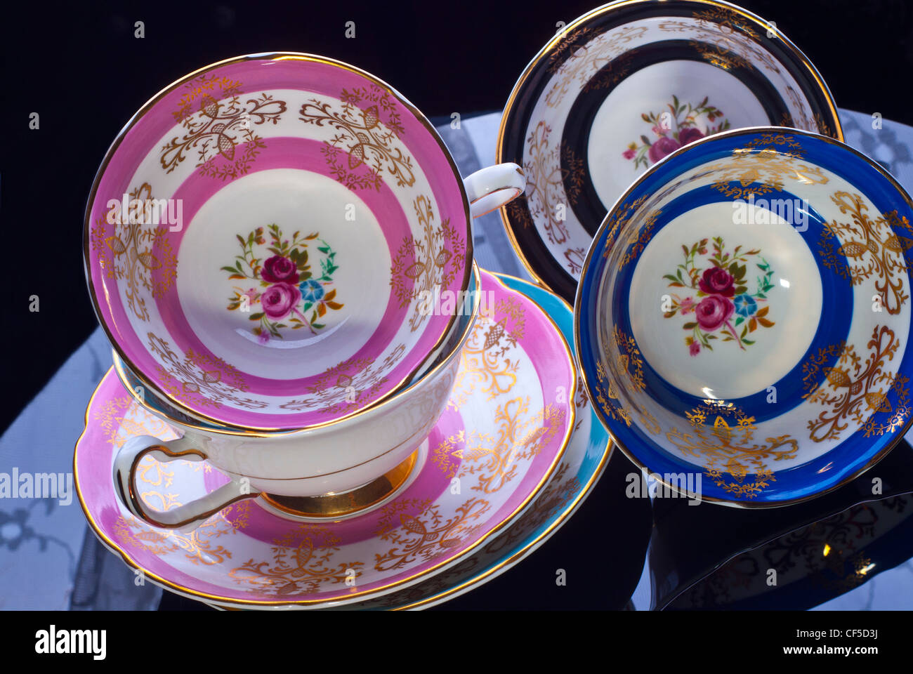 Beautiful colourful best china Cups & Saucers displayed on glass table ...