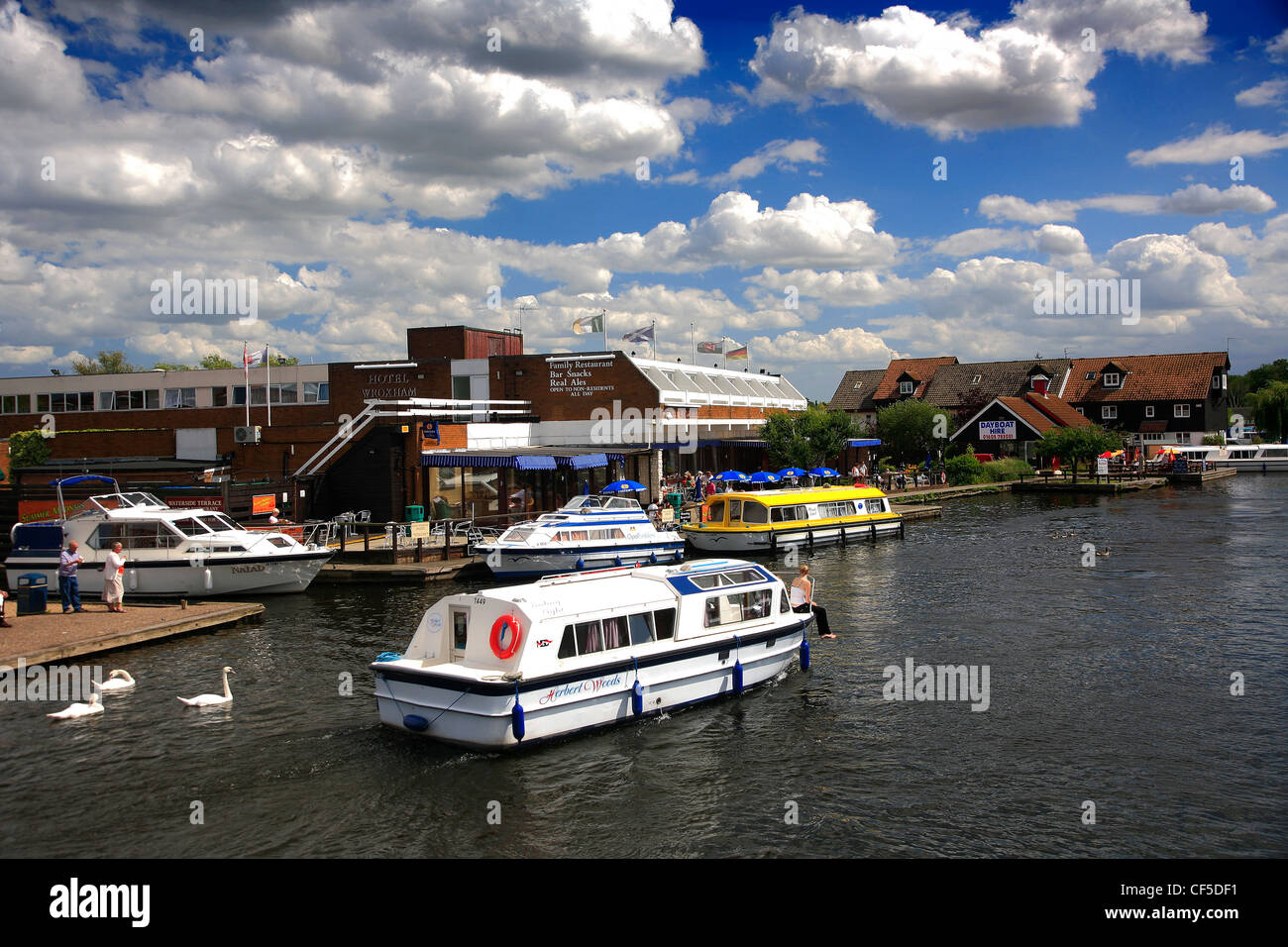 Pleasure boats on the River Bure at Wroxham town in the Norfolk Broads ...