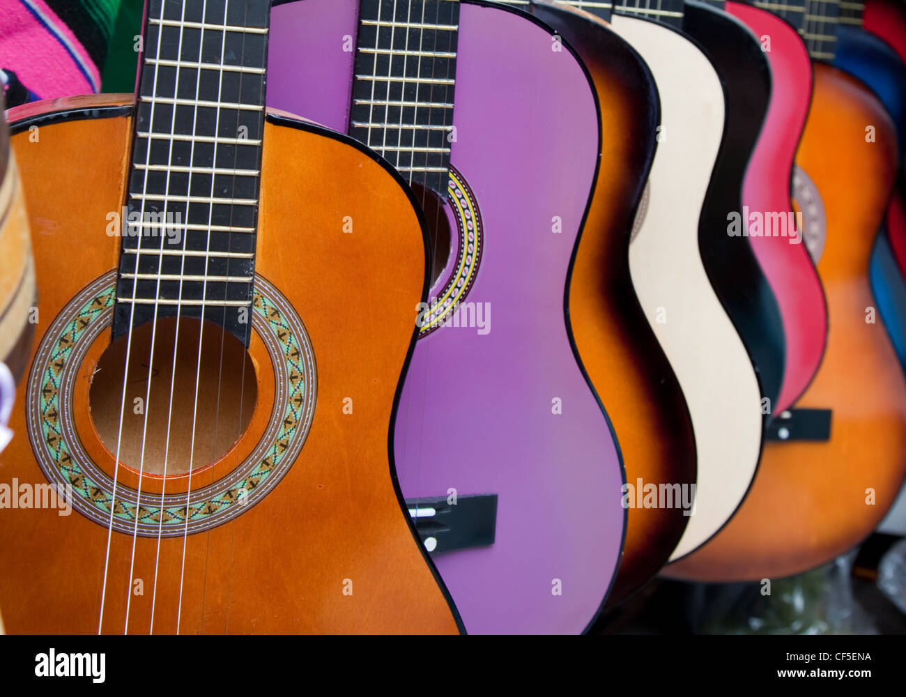 A group of brightly colored Mexican made guitars on display Stock Photo ...