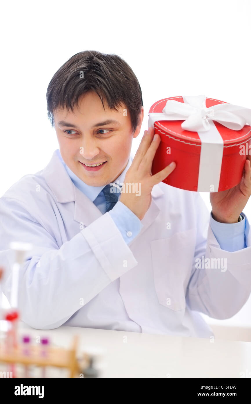 Happy medical doctor shaking present box trying to guess whats inside ...