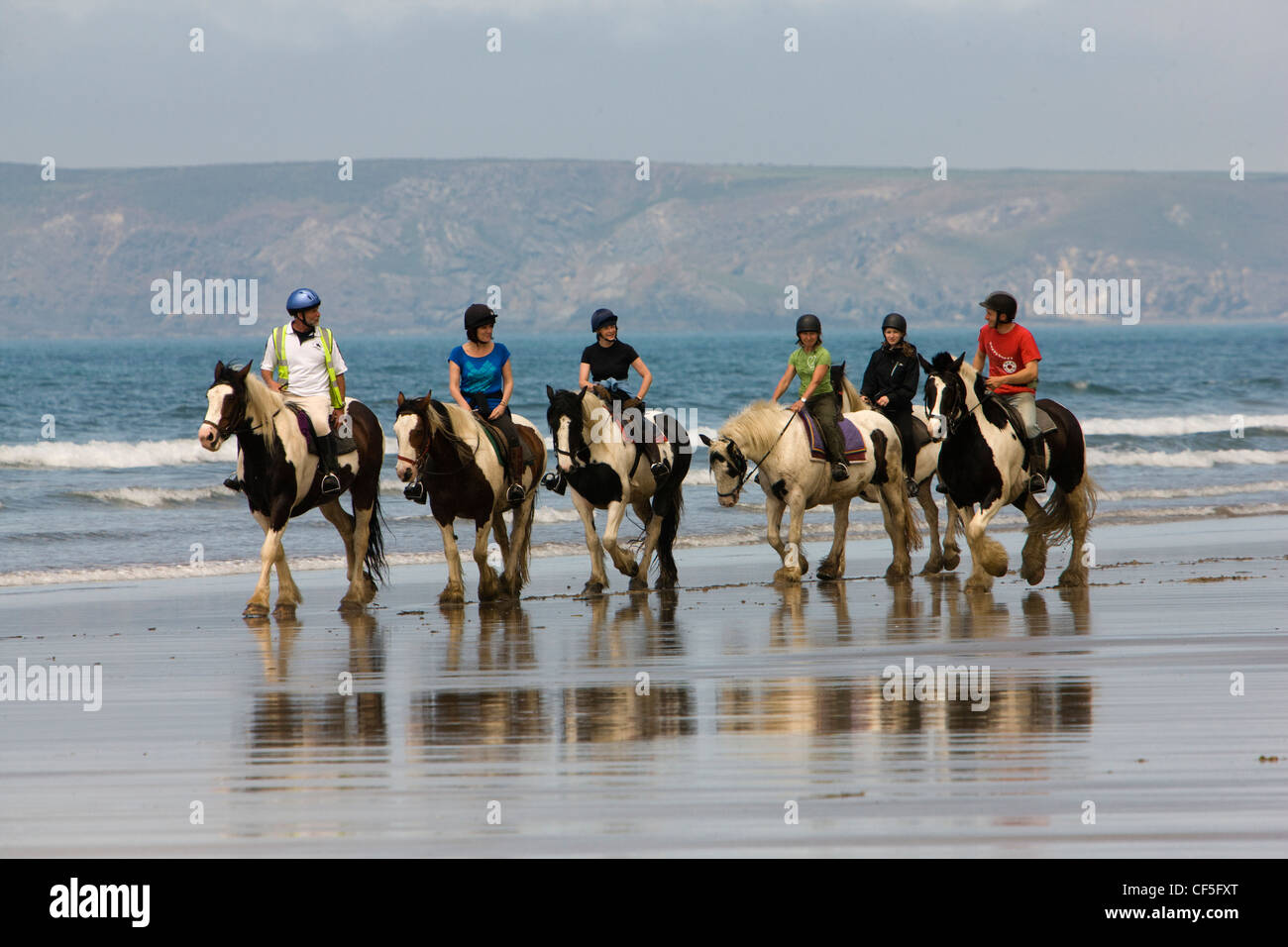 Pony trekking holiday group on the beach of Druidstone Haven in ...
