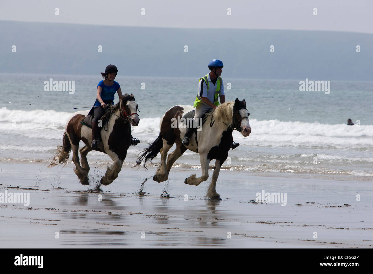 Pony trekking holiday group on the beach of Druidstone Haven in ...