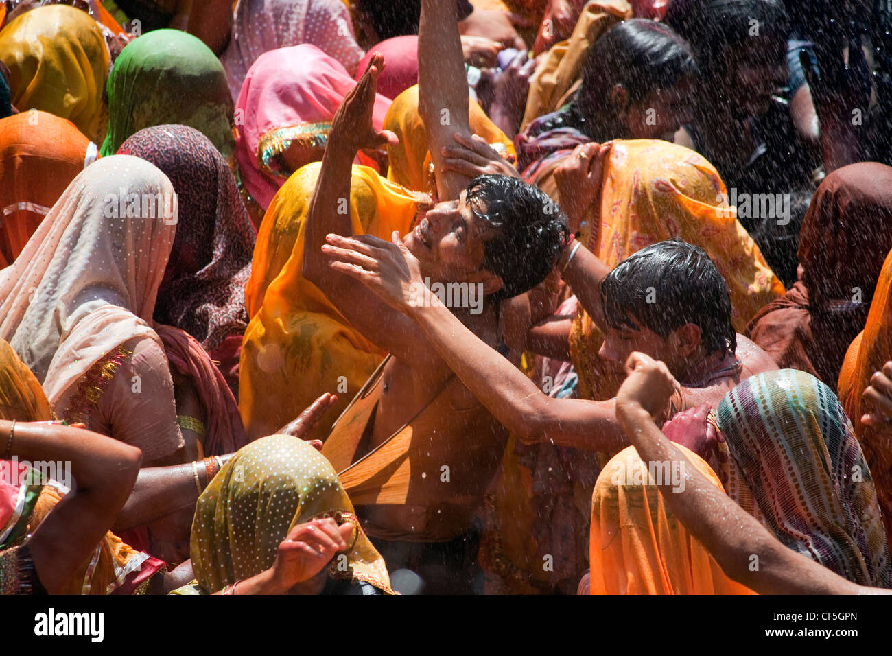 Crowds of people celebrate Holi festival in Mathura, India Stock Photo ...