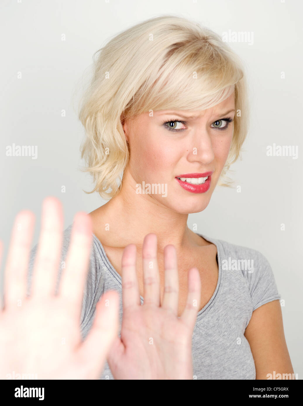 Female with hands raised in a pushing away movement Stock Photo - Alamy