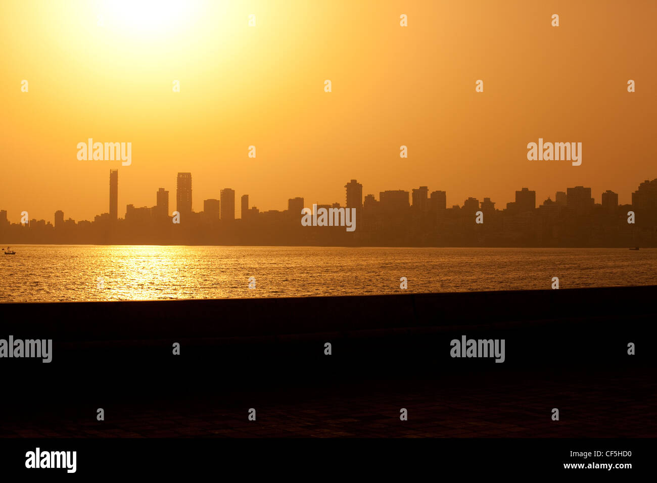 Mumbai skyline across water at sunset Stock Photo - Alamy