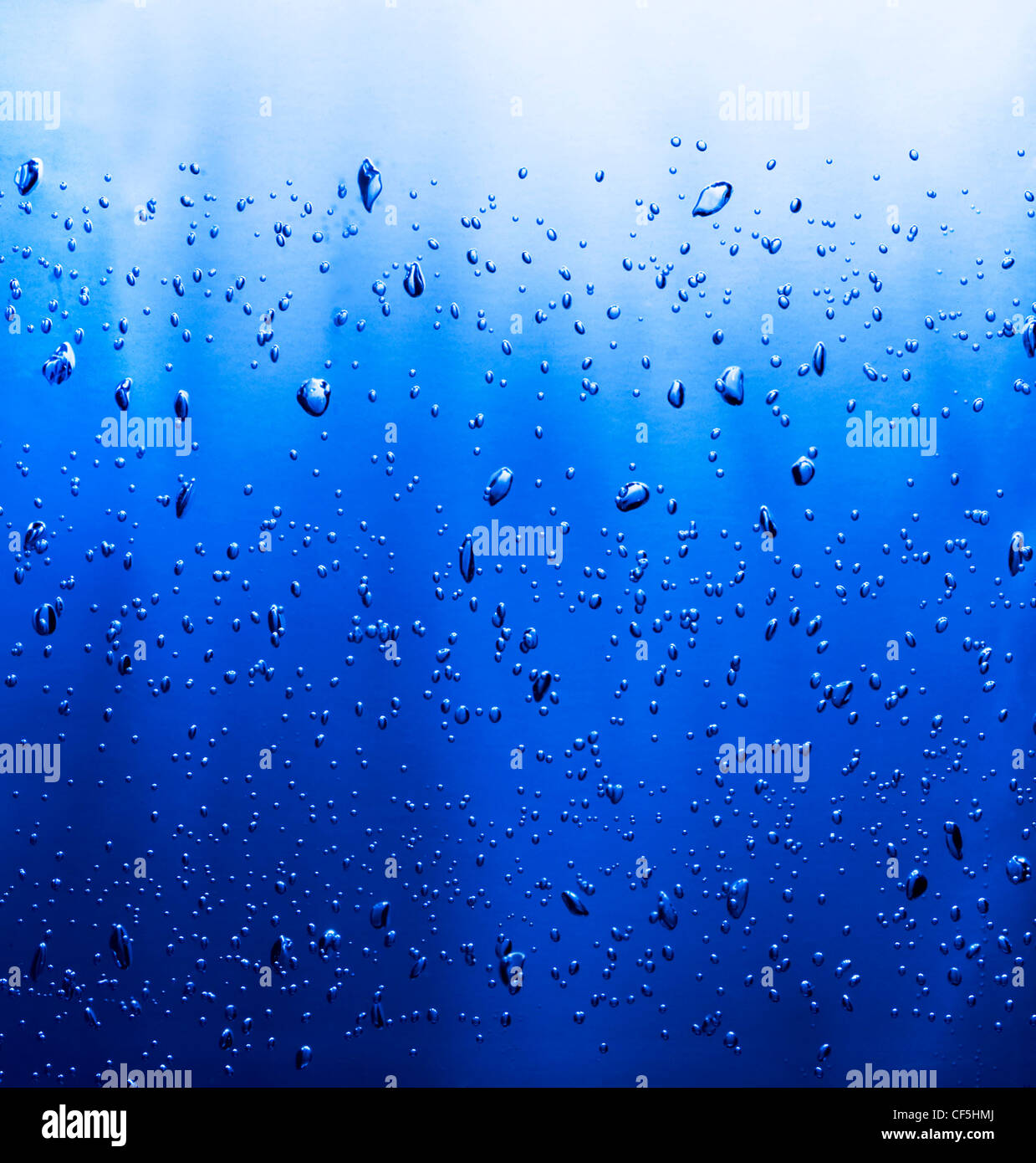 Side view of bubbles rising up in a blue liquid. Square shot Stock ...