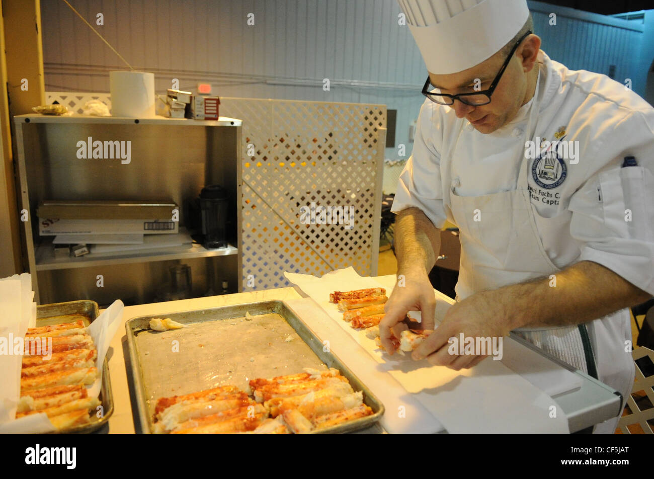 U.S. Coast Guard Petty Officer 1st Class Edward Fuchs prepares crab to ...