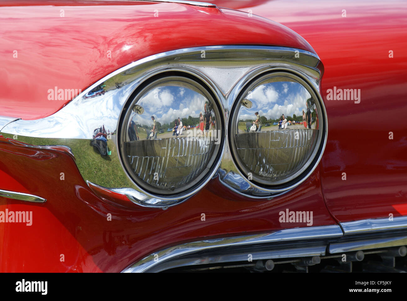 A reflective view of the spectators at the classic car show at ...