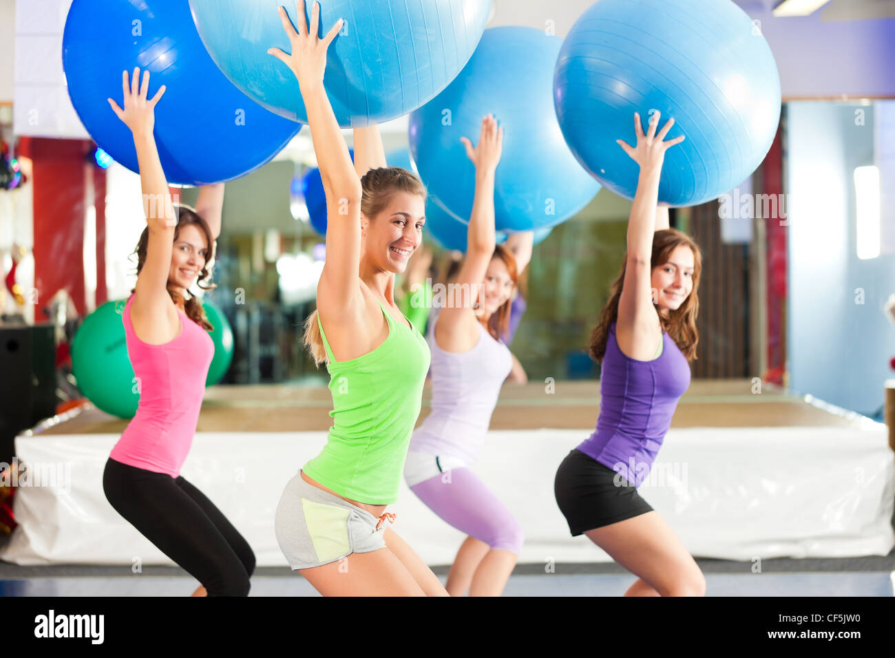 Fitness - Young women doing sports training or workout with gymnastic ...