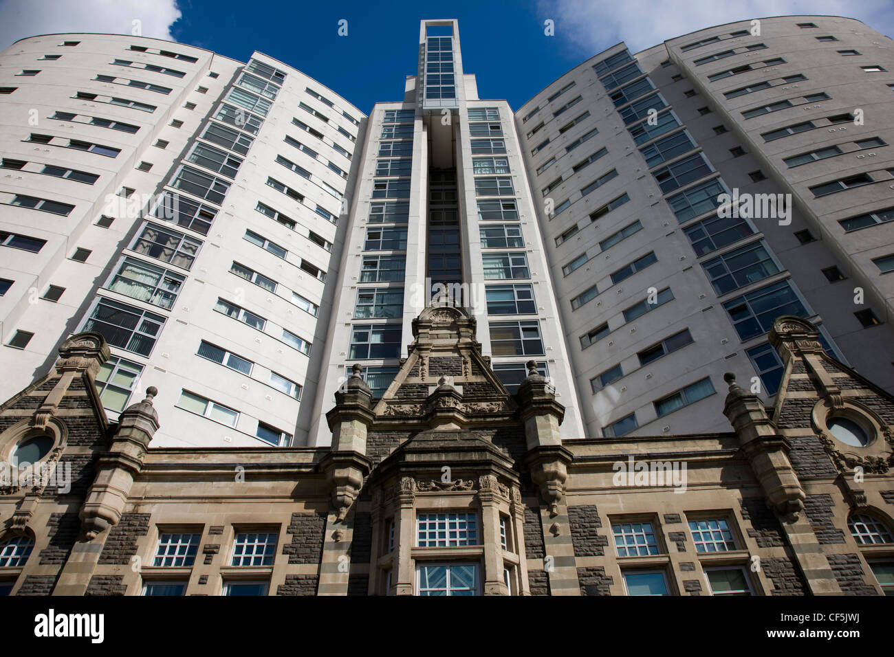 Modern high-rise tower block flats behind Victorian facade of older ...