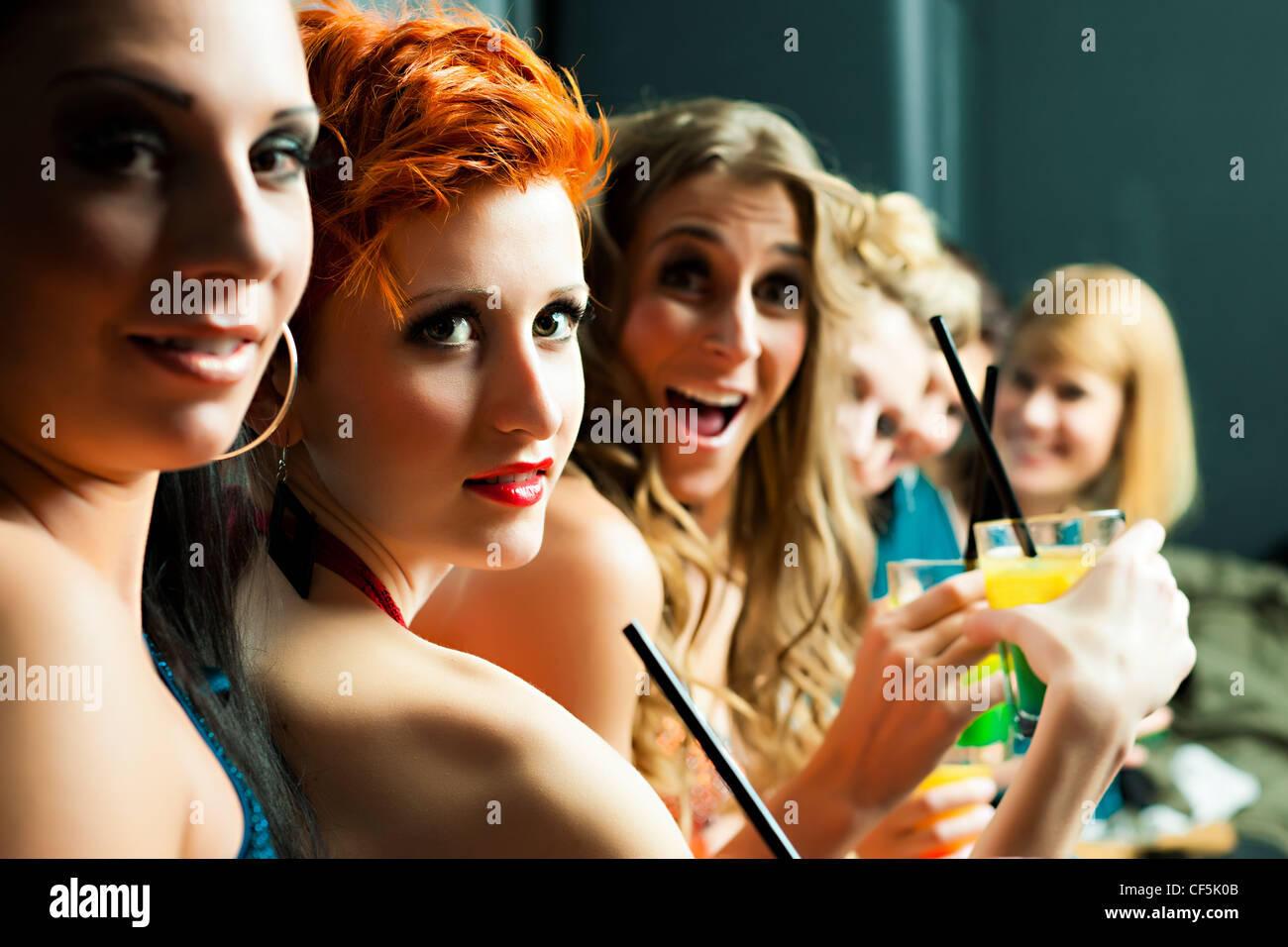 Women or models in club or disco drinking cocktails having fun Stock ...
