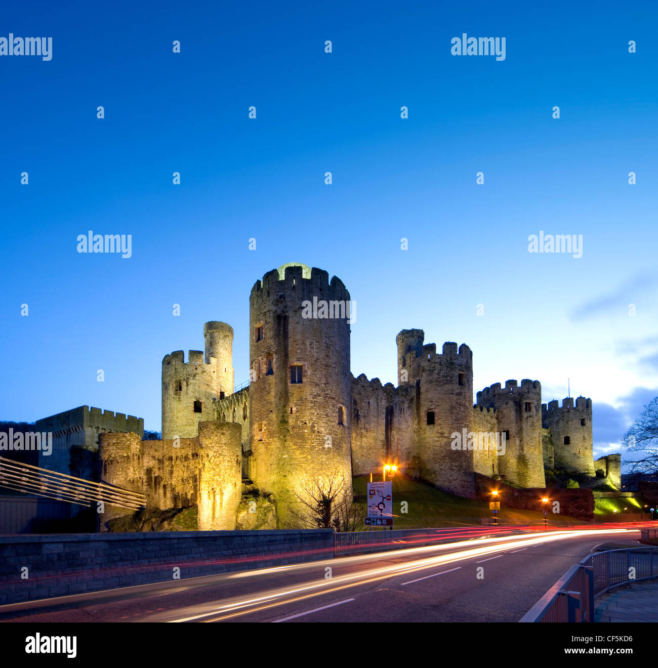 Conwy Castle lit up at dusk. The castle was an important part of King ...