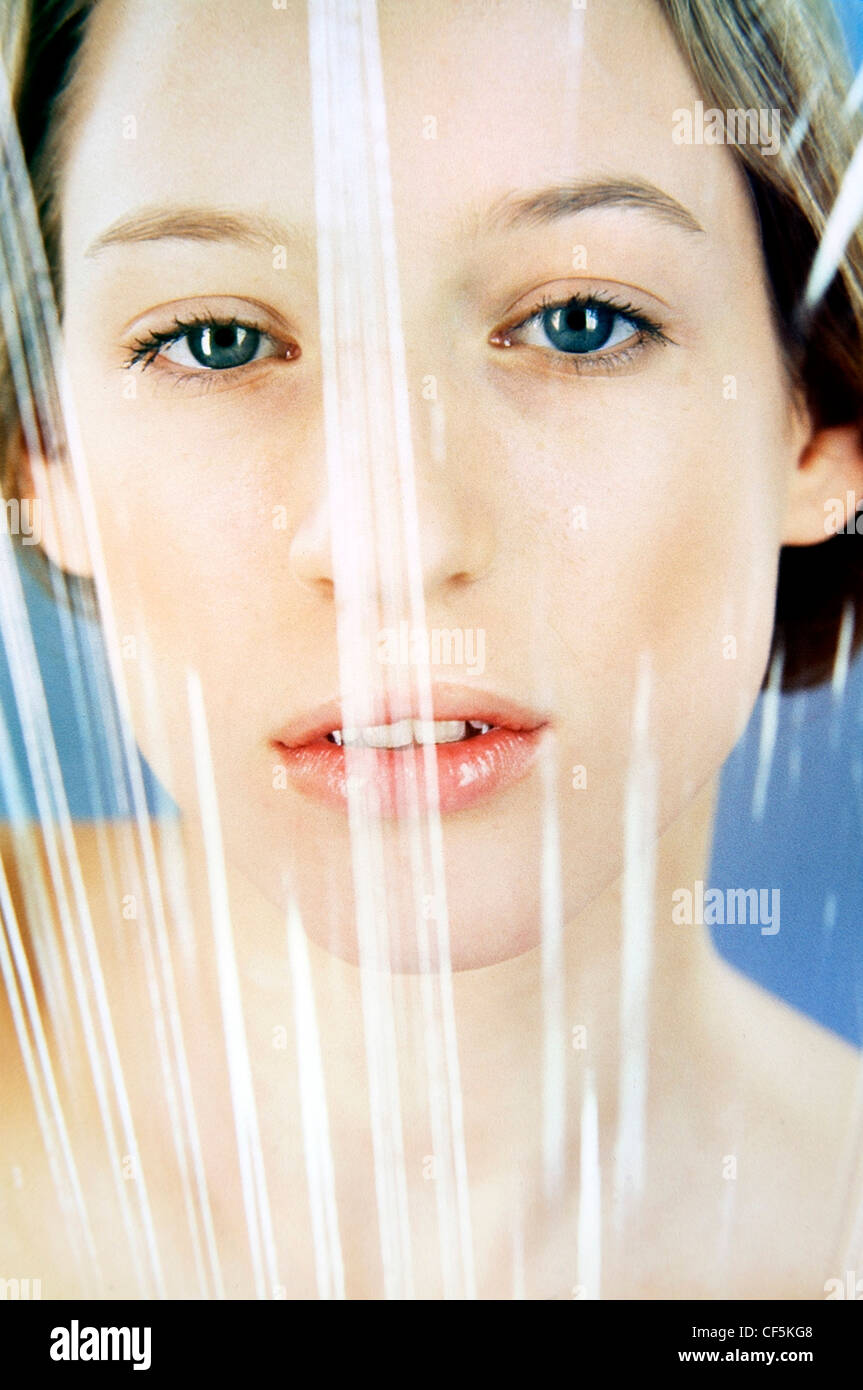 Female with fair hair off her face, wearing natural make up, unsmiling ...