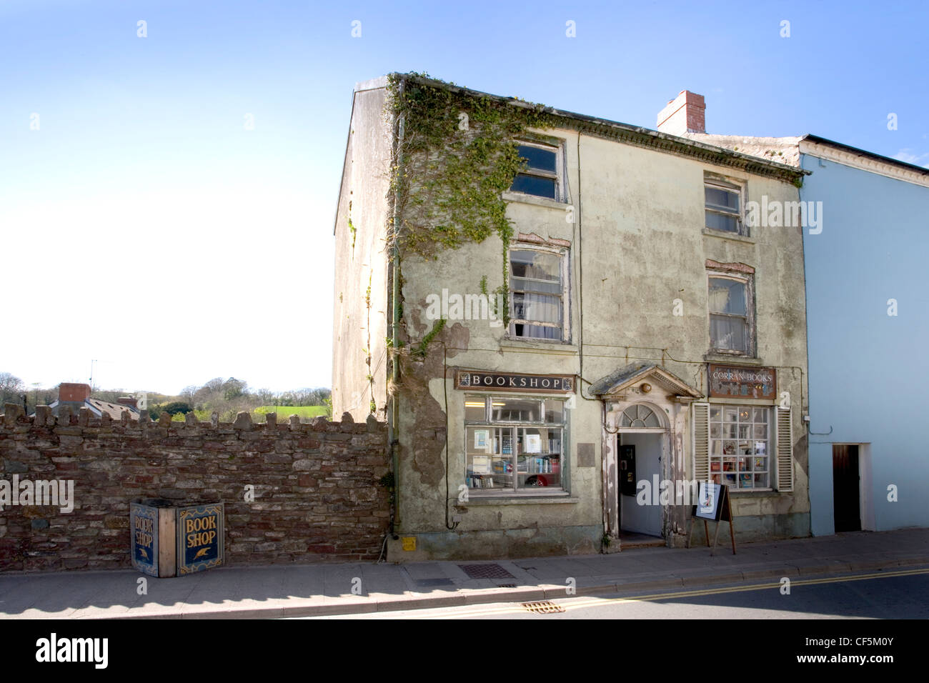A view of Corran Book Shop attached to a pale blue building. Laugharne ...
