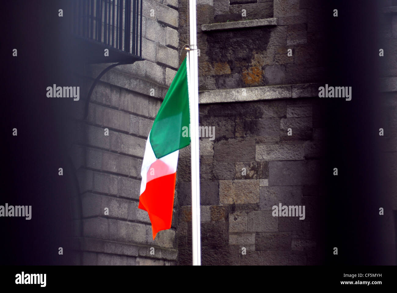 An Irish flag hanging from a pole in Central Dublin Stock Photo - Alamy