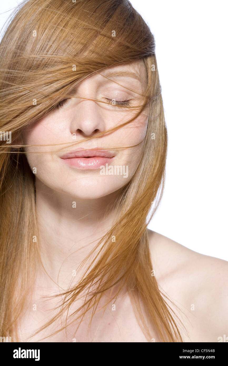 Female with long straight fair hair over face, unsmiling, with her eyes ...