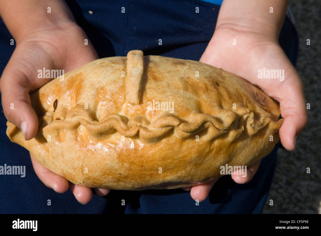 A cornish pasty about to be eaten Stock Photo - Alamy