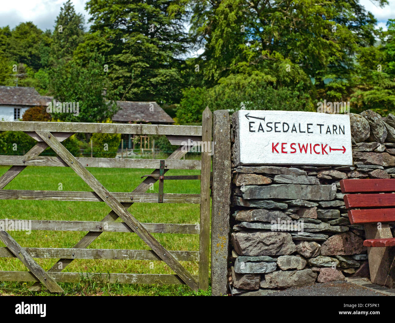A hand carved sign with directions to Easedale Tarn and Keswick on a ...