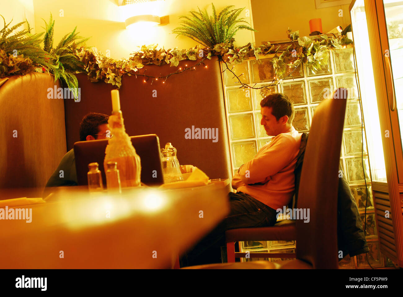 Interior view of men sitting at a restaurant table in Cork Stock Photo ...