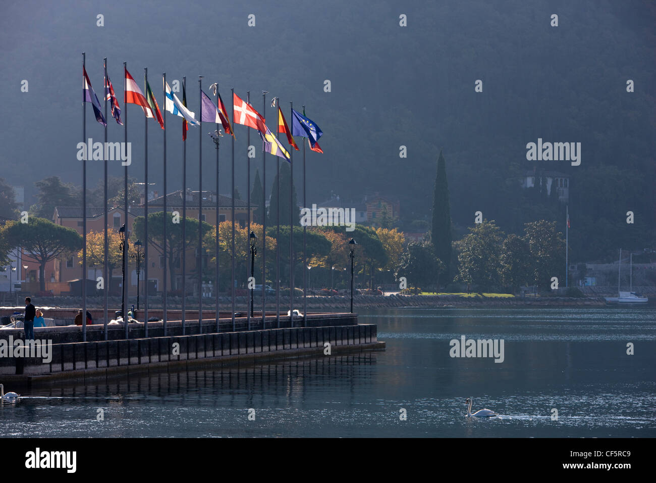 Flags along the harbour wall in Bardolino, Lake Garda, Italy Stock ...
