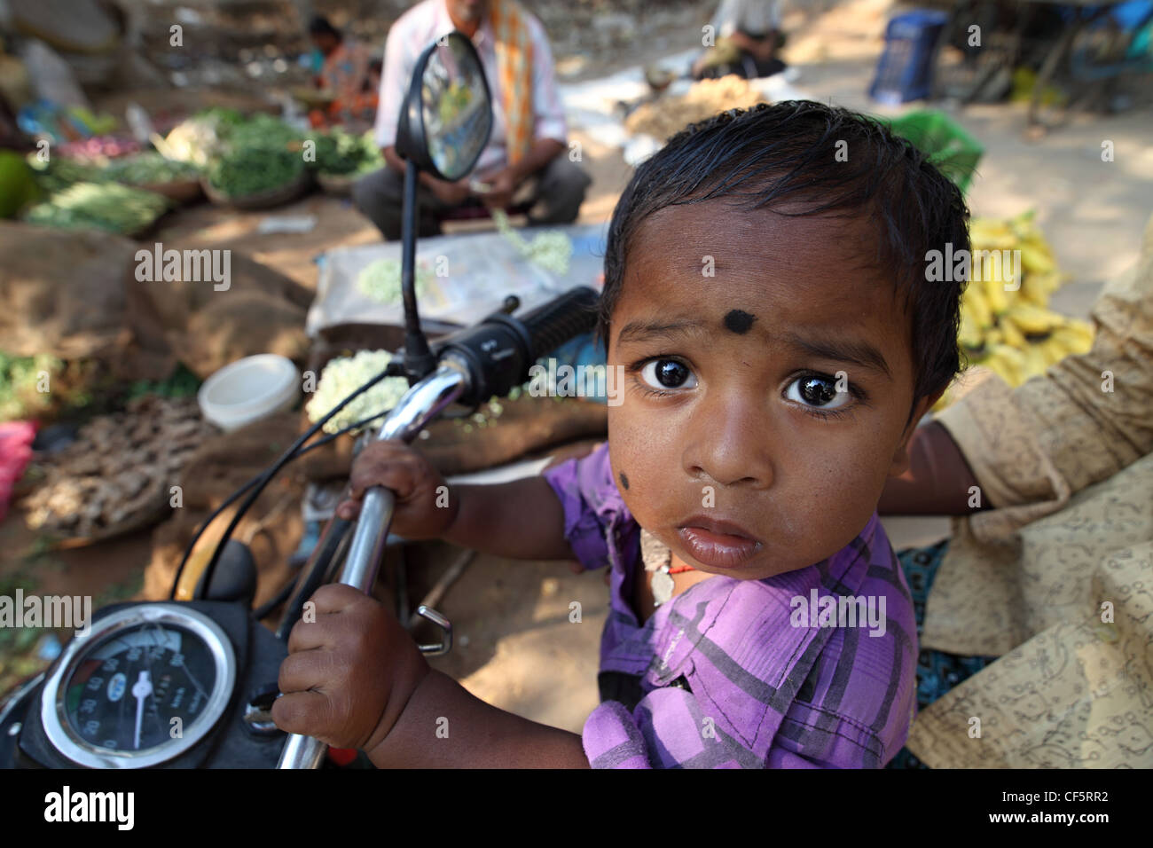 Little boy on his fathers motorbike Andhra Pradesh South India Stock ...