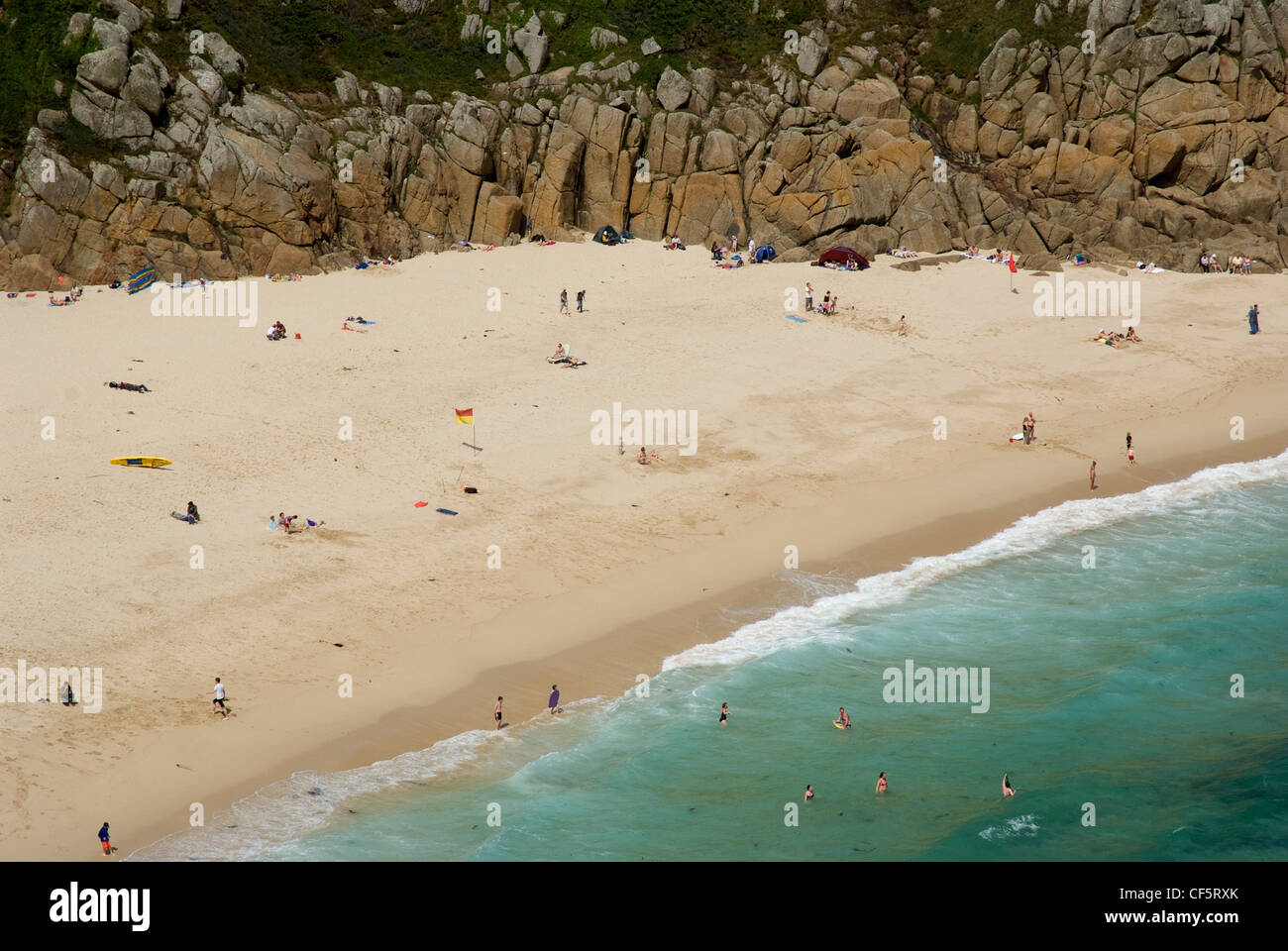 People enjoying the beach at Porthcurno Bay below the Minack Theatre ...