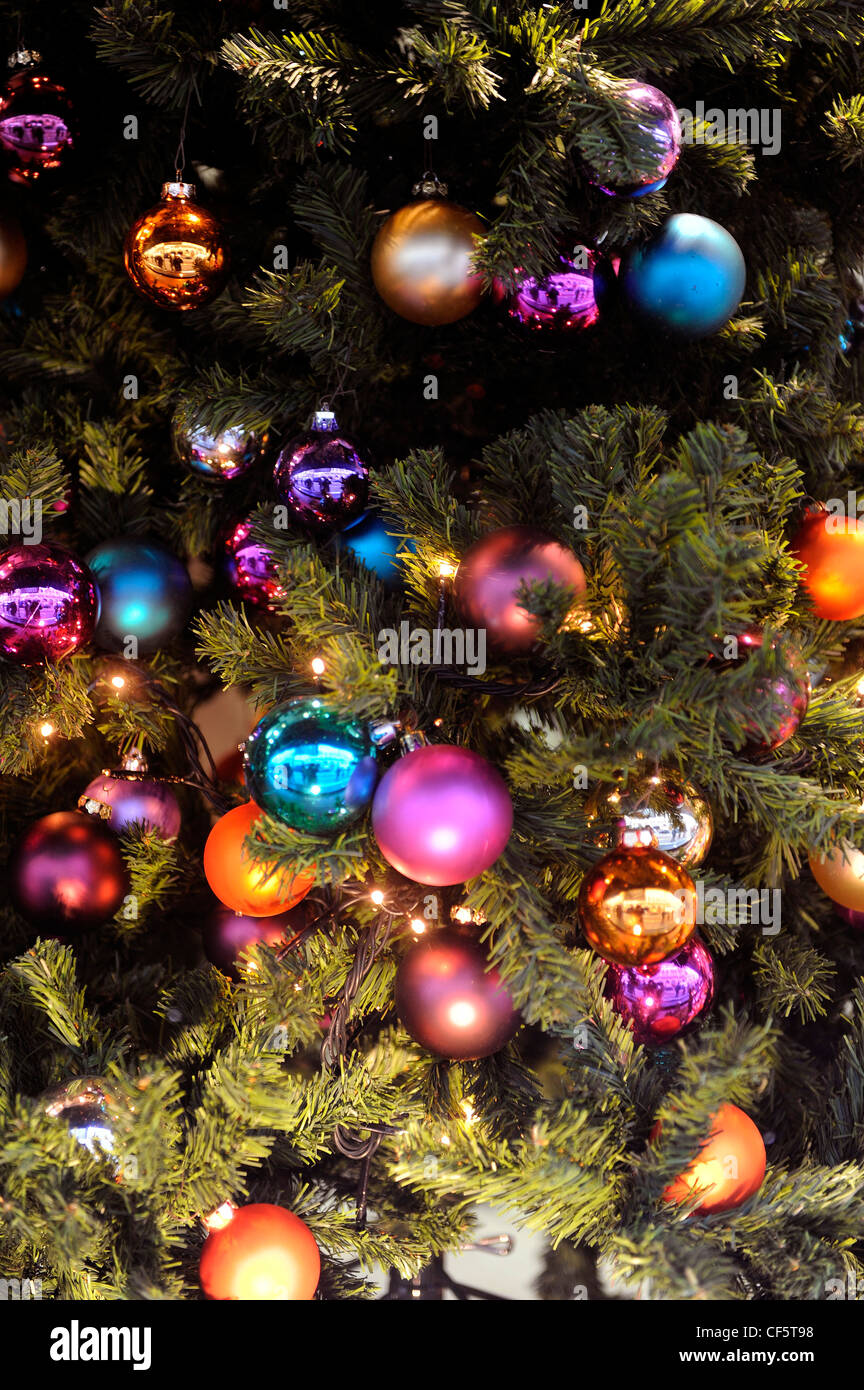 Christmas tree detail decorated with colourful baubles Stock Photo - Alamy