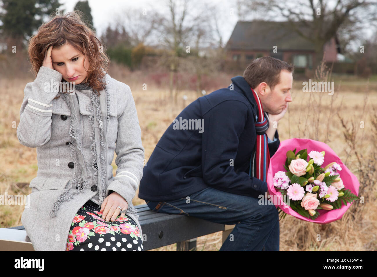 Annoyed couple facing difficulties while sitting on bench Stock Photo ...