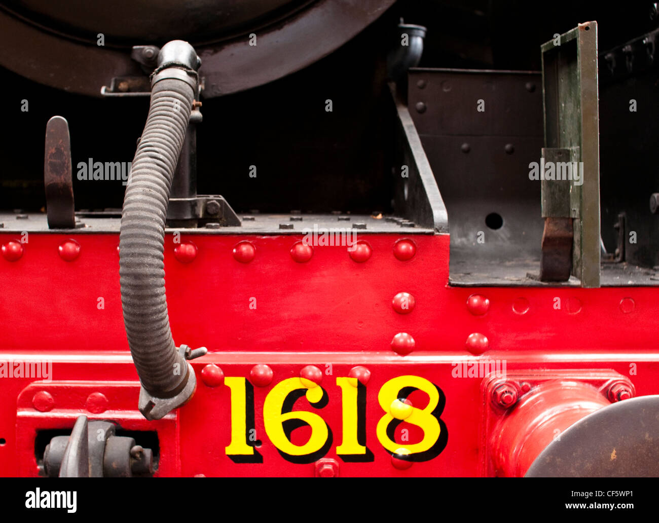 A close up of painted text on a red steam engine at sheds in Horsted ...