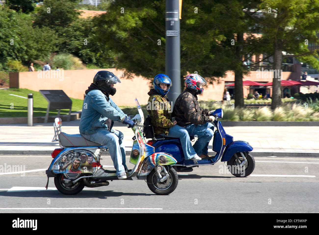 People riding scooters in Liverpool city centre Stock Photo - Alamy