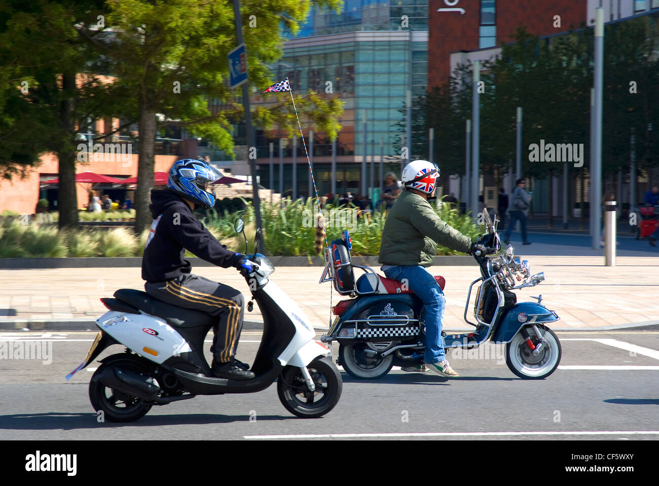 People riding scooters in Liverpool city centre Stock Photo - Alamy