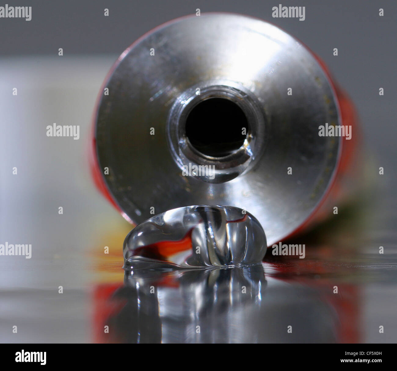 A red tube of clear gel, on a reflective surface Stock Photo - Alamy