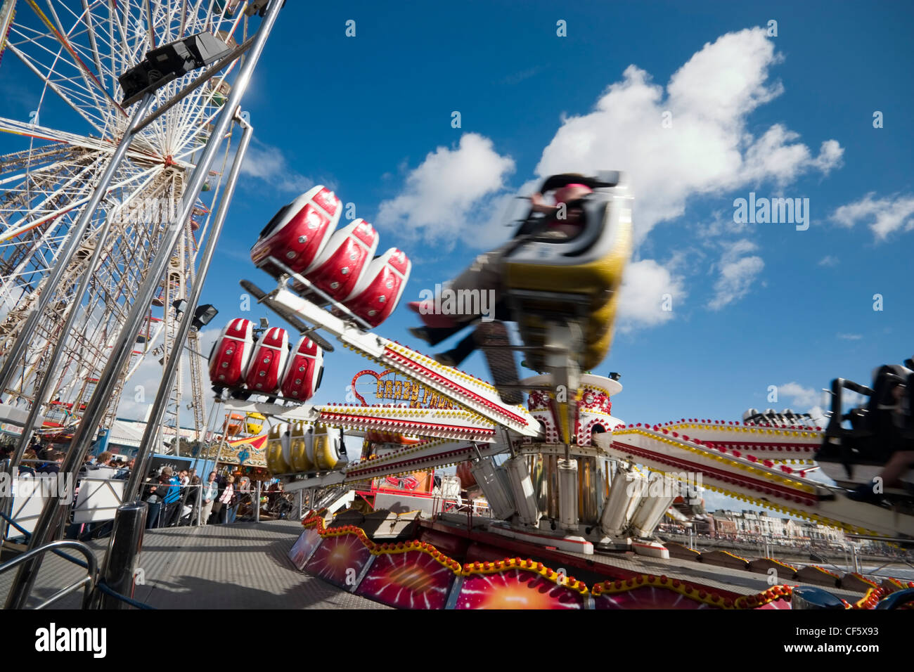 People enjoying a fairground at Blackpool. The town is believed to get ...