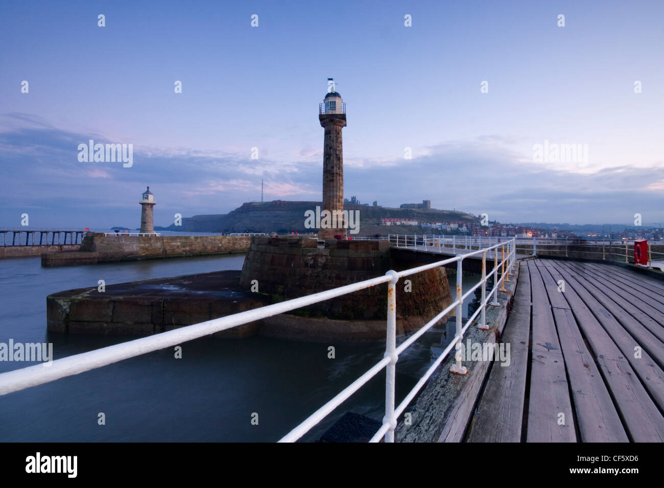 Evening view along the railings of Whitby Pier. A large portion of Bram ...