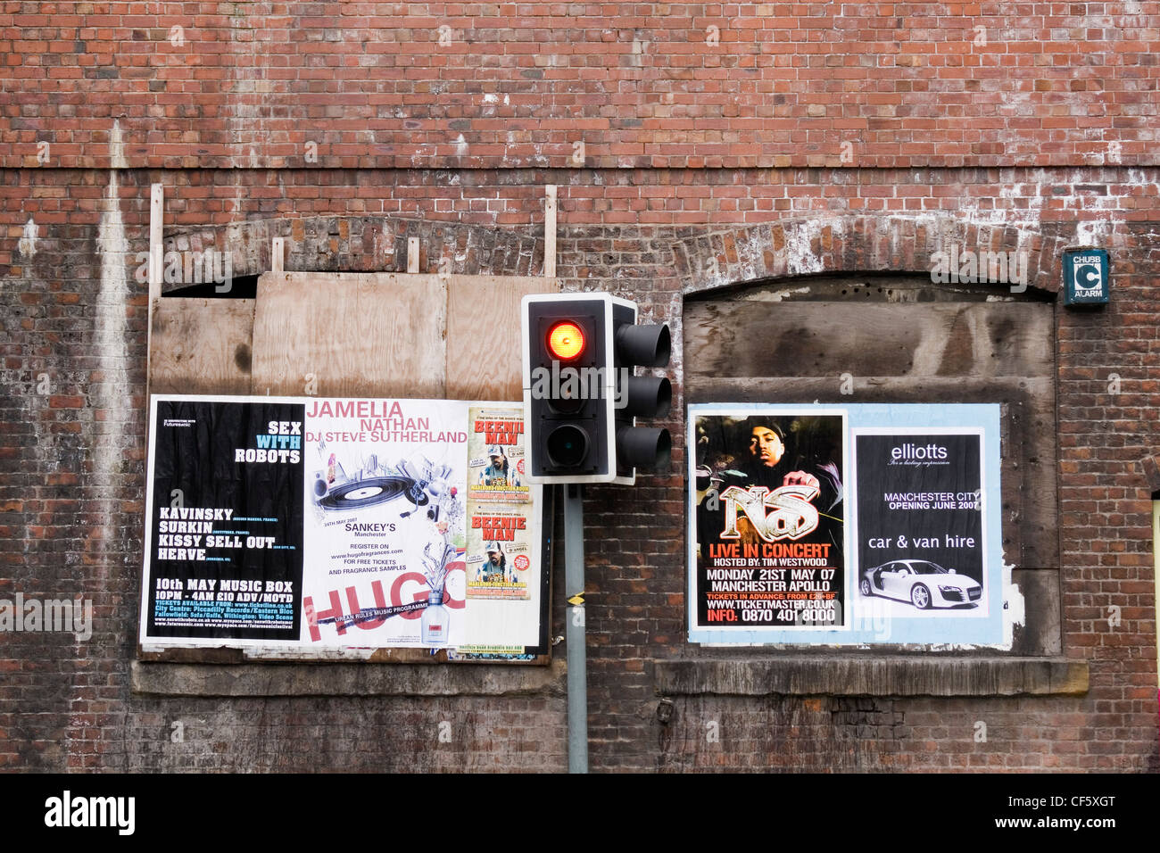 Traffic light and fly posters in Manchester Stock Photo - Alamy