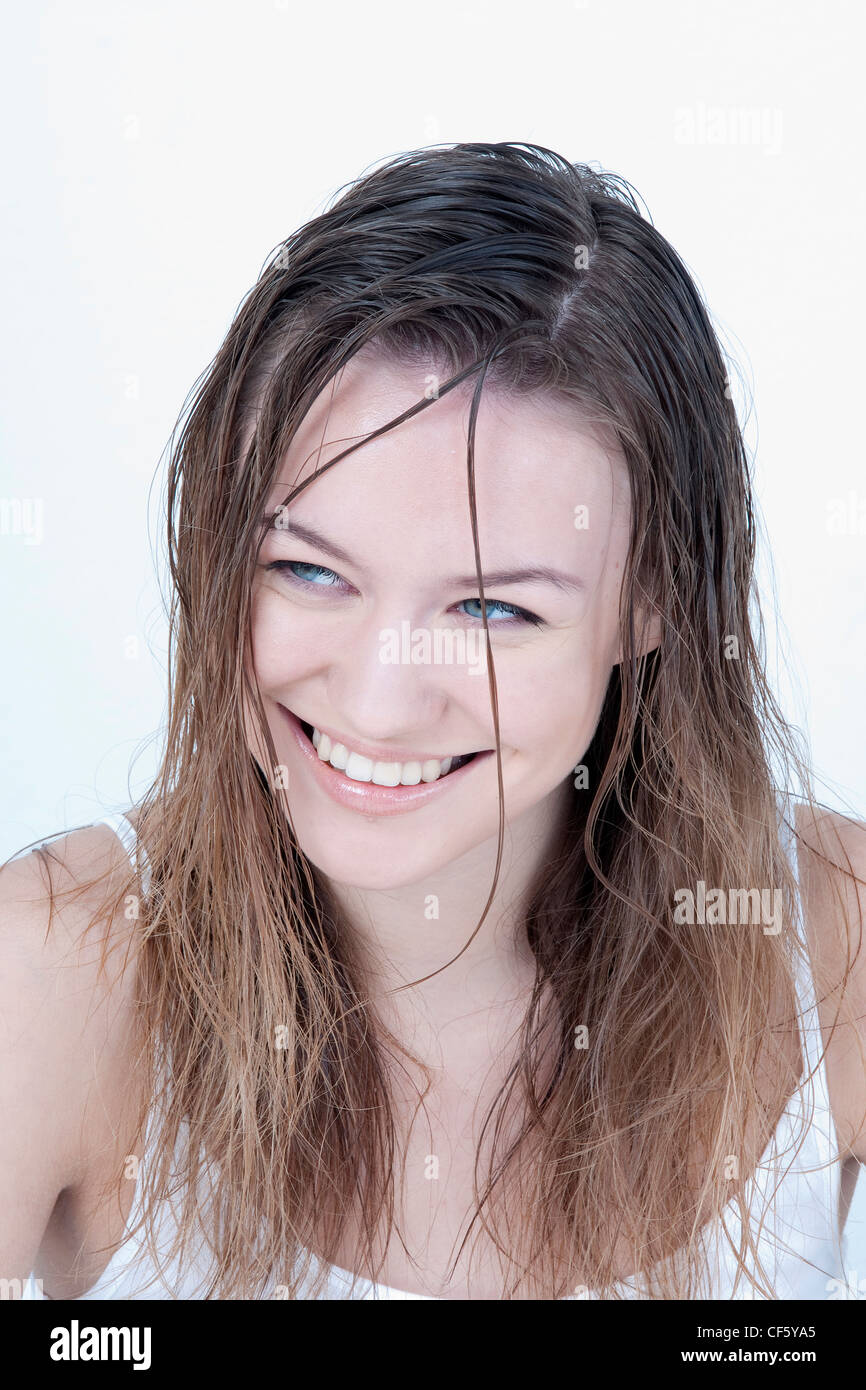 Female with brunette hair over face, wearing white camisole, black ...