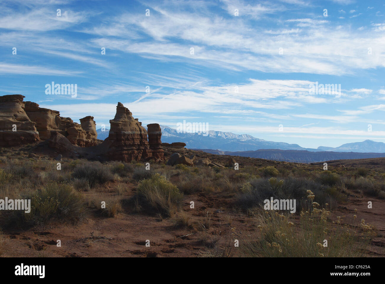 Soft light on desert and rocks with Henry Mountains, Utah Stock Photo ...