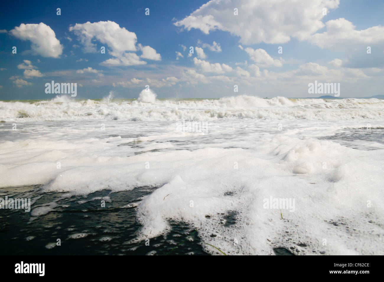 Strong wind creates big waves crashing onto the black sandy beach Stock ...