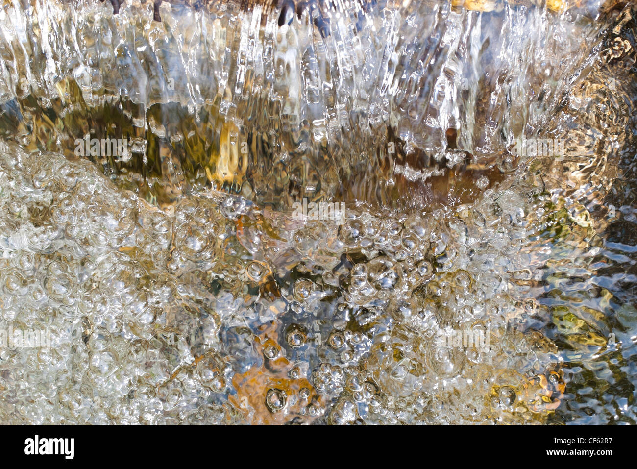 Pure mountain stream water flowing and creating bubbles Stock Photo - Alamy
