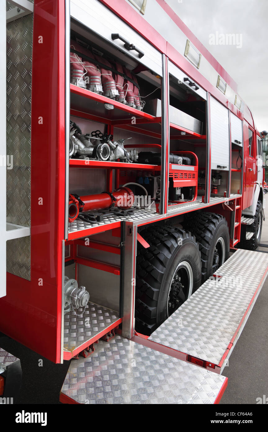 Fire cocks and hoses equipped inside big red fire engine at day Stock ...