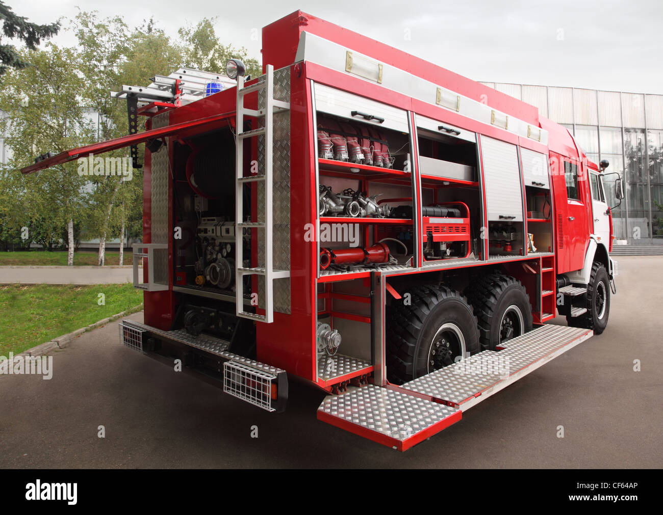 Side view of fire cocks and hoses equipped inside big red fire engine ...