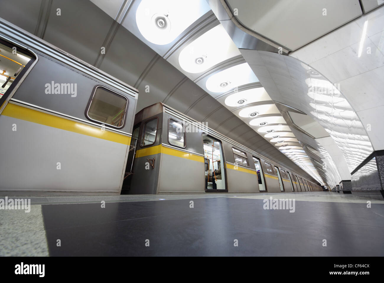 modern grey train on metro station with opened doors, granite floor ...