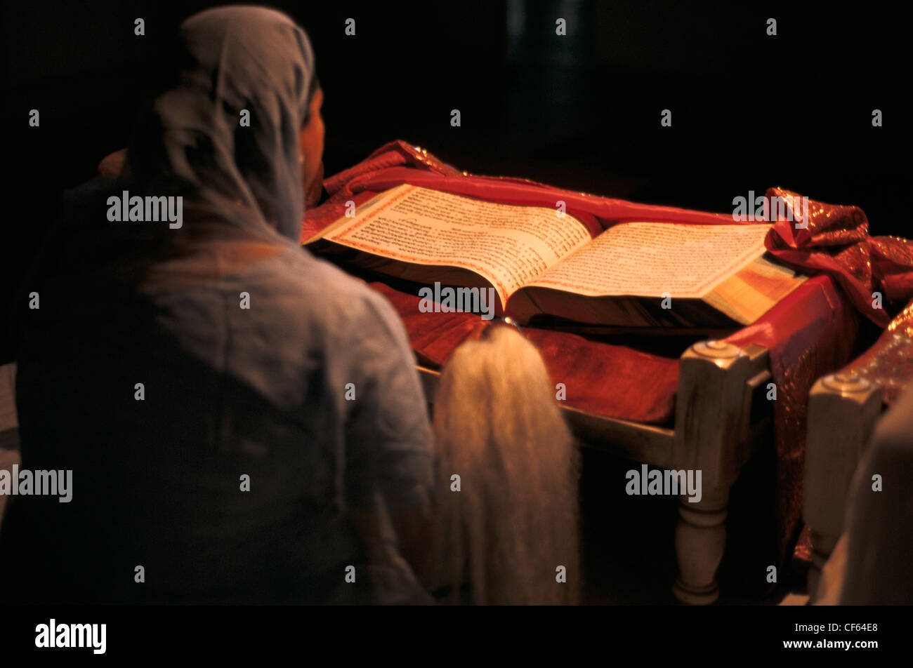 Sikh woman reading the "guru granth sahib", the sikh sacred book ...