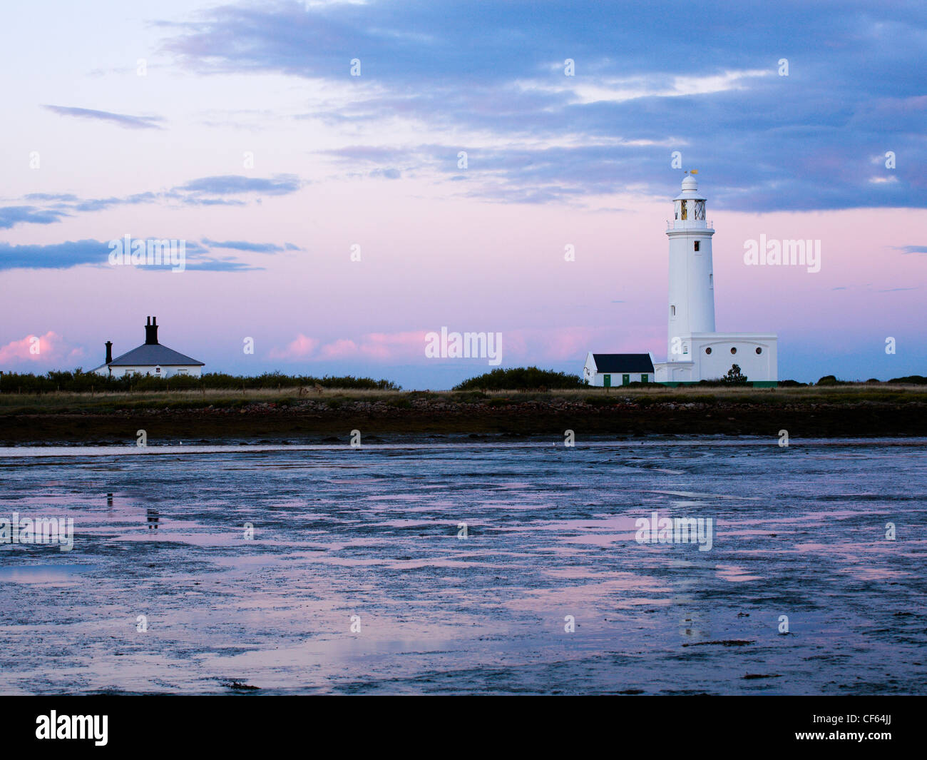 Hurst Point Lighthouse at the end of Hurst Spit, a shingle bank that ...
